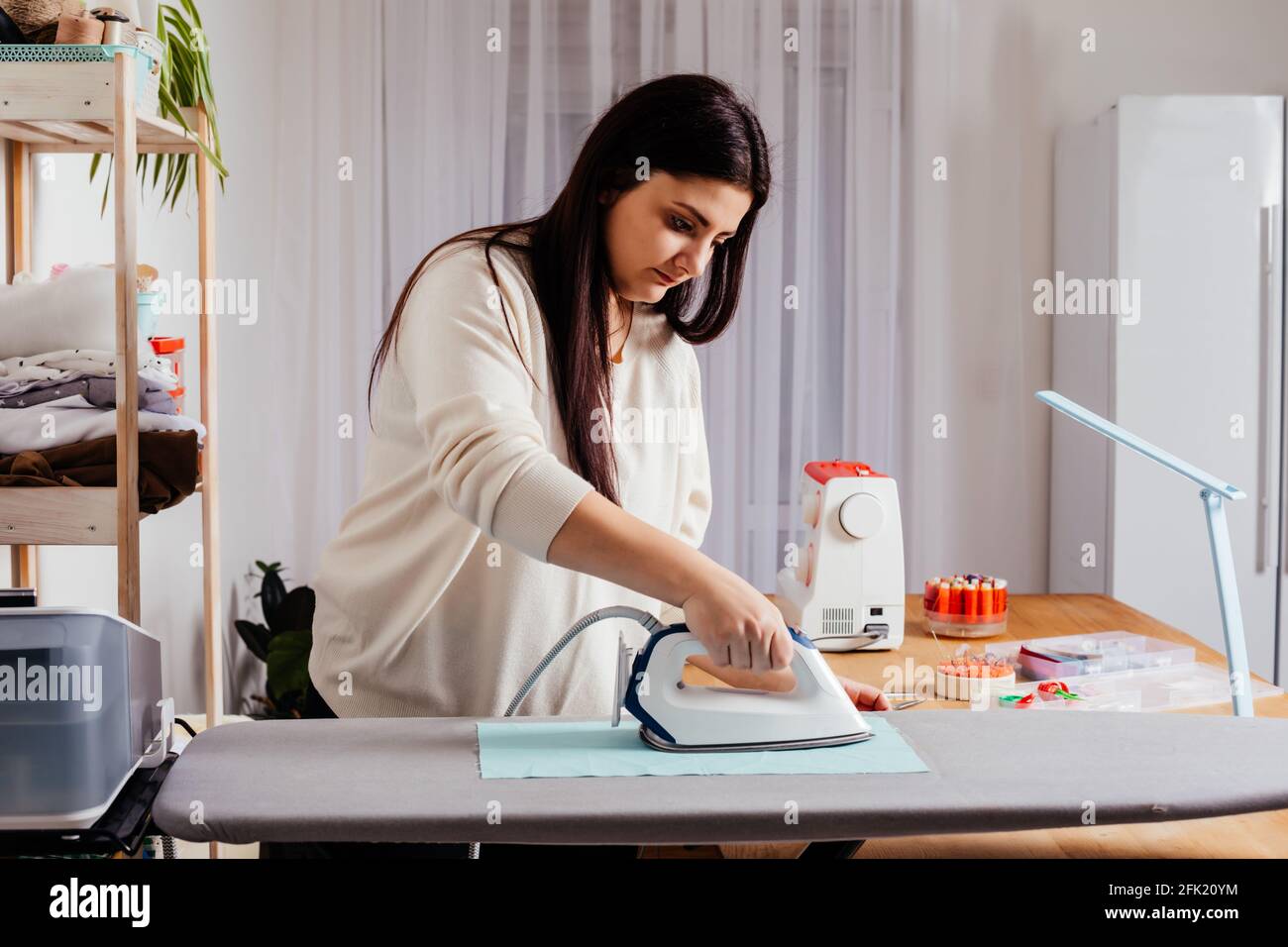 Process of ironing textile before cutting the pattern and sewing Stock ...