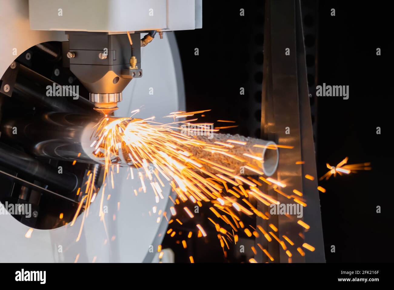 Cnc laser cutting machine working with cylindrical metal workpiece with ...