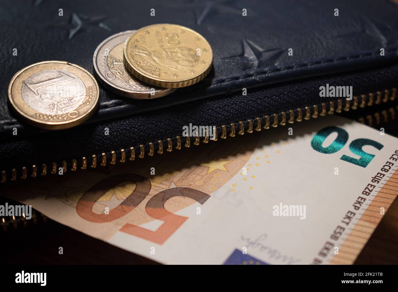 Blue leather wallet with money 50 euro banknote inside it and coins on ...