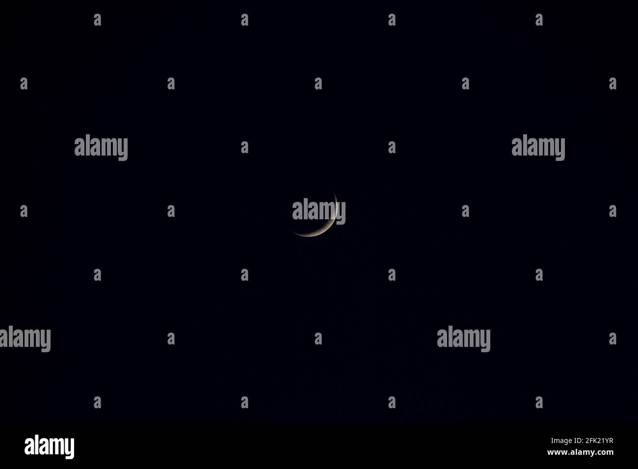 Waxing crescent moon in a dark night sky in spring Stock Photo - Alamy