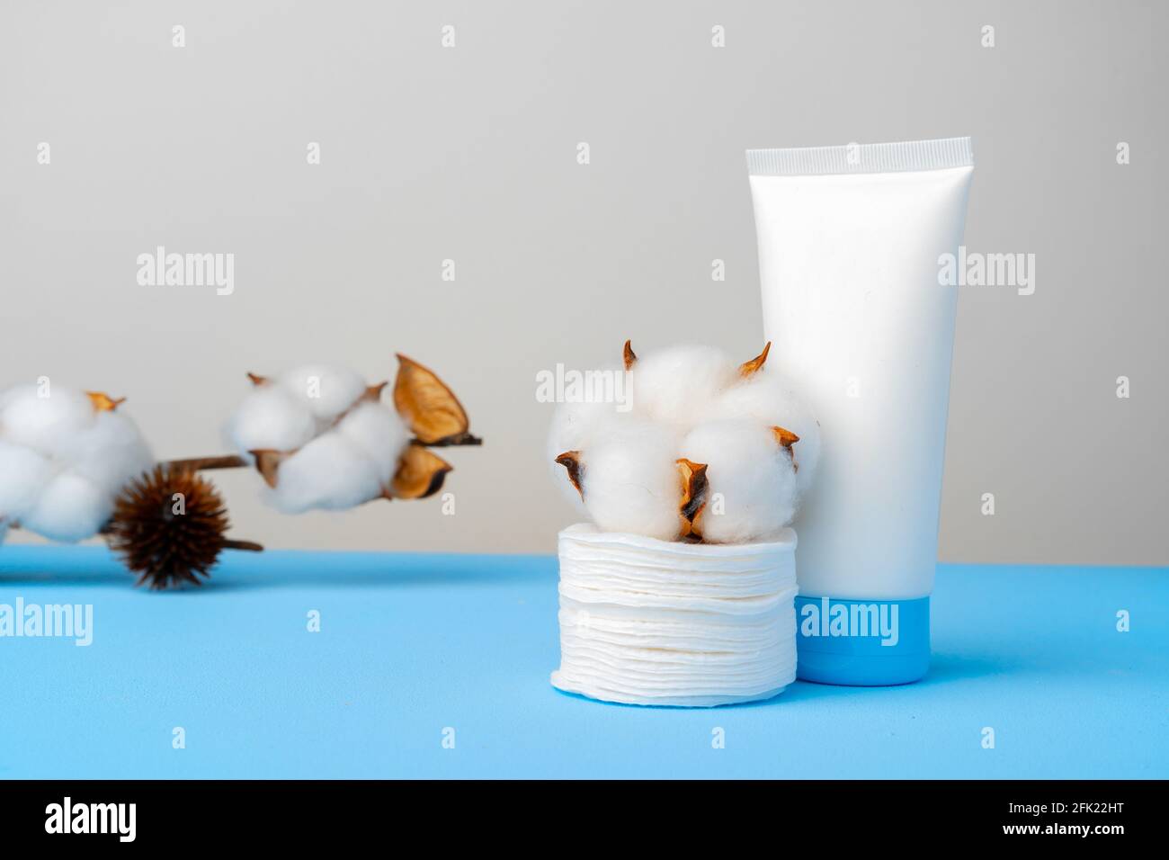 Cleansing gel and stack of cotton pads on paper background Stock Photo ...
