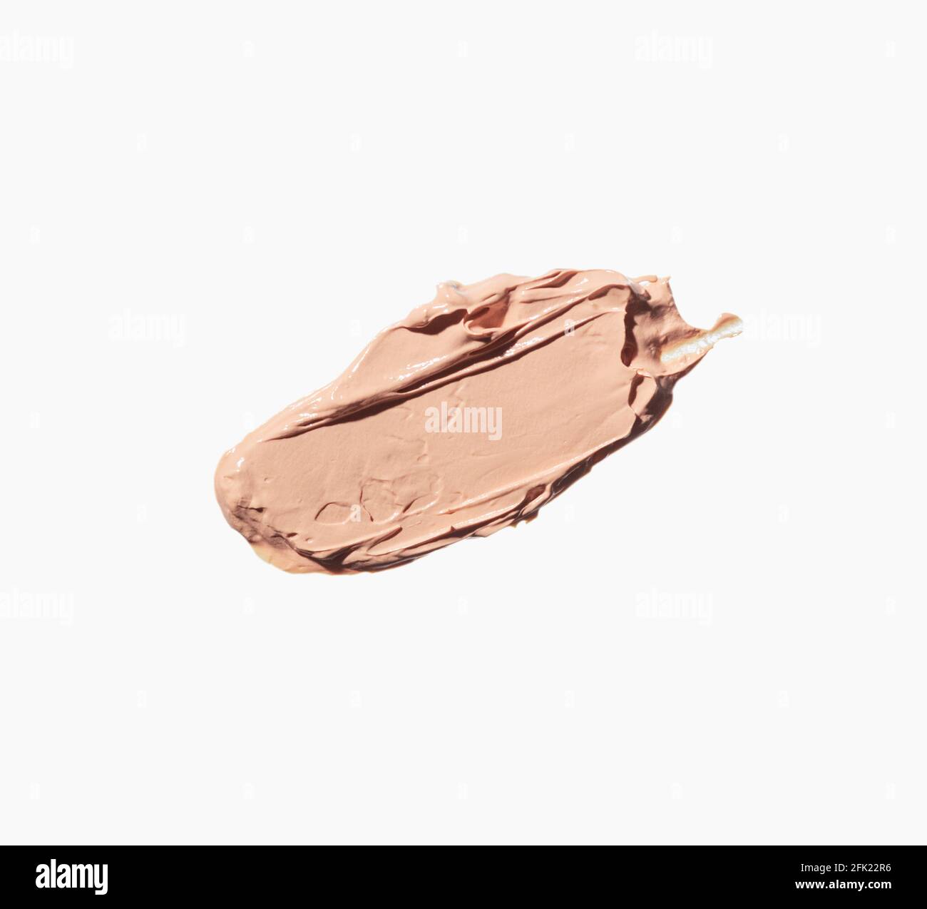 A smear of makeup foundation isolated on a white background. Swatch ...