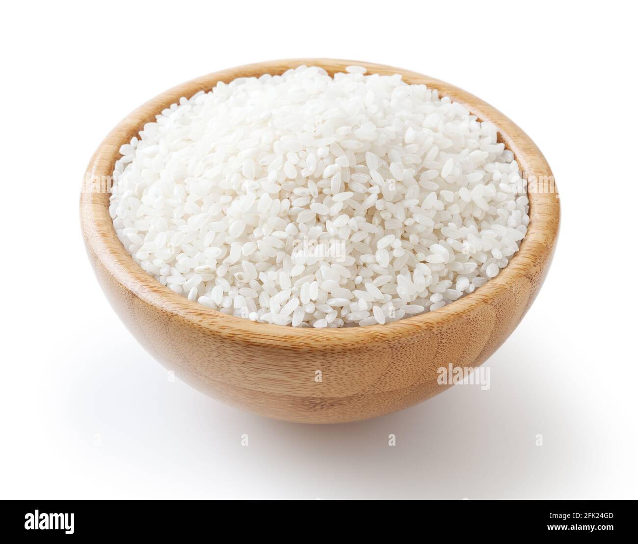 Uncooked round rice in wooden bowl isolated on white background with ...