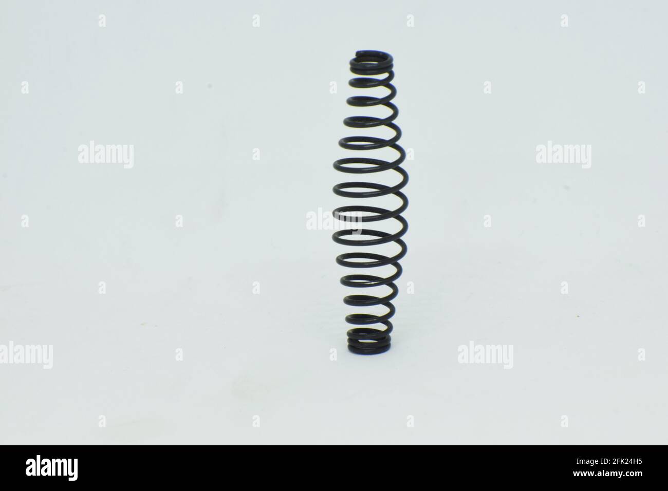 Black metal spring isolated in the light gray background Stock Photo ...