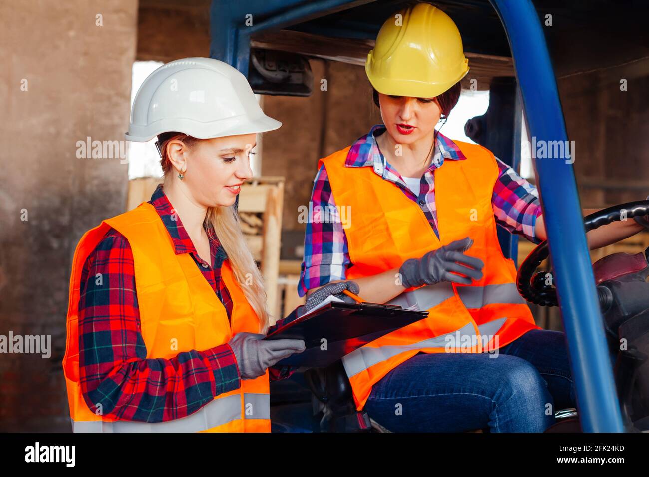 Young female warehouse workers solving working issues Stock Photo - Alamy