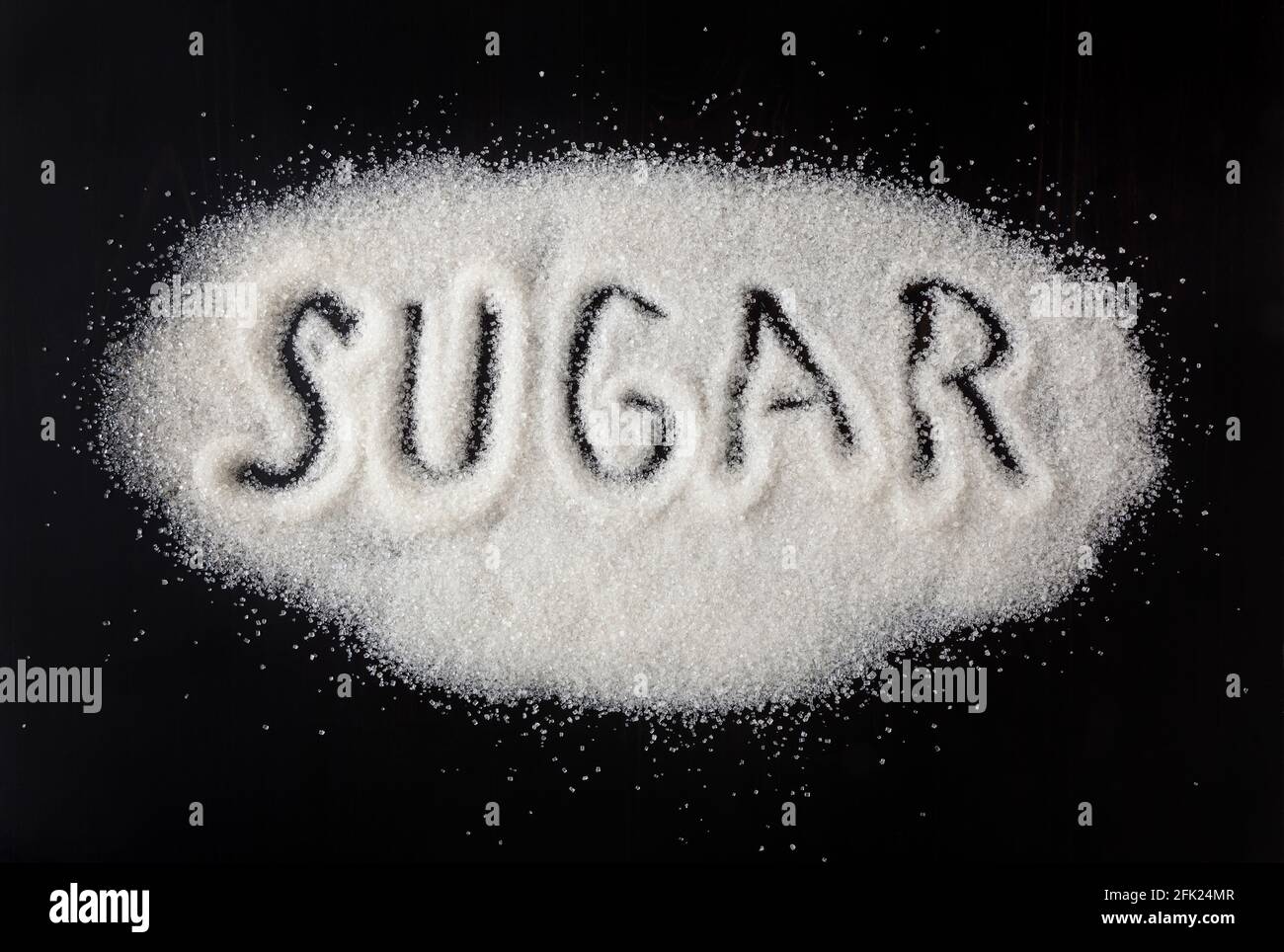 Heap of granulated white sugar on black background Stock Photo - Alamy