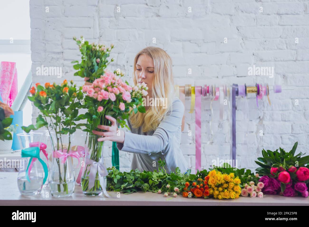 Portrait of professional floral artist working with flowers at studio ...