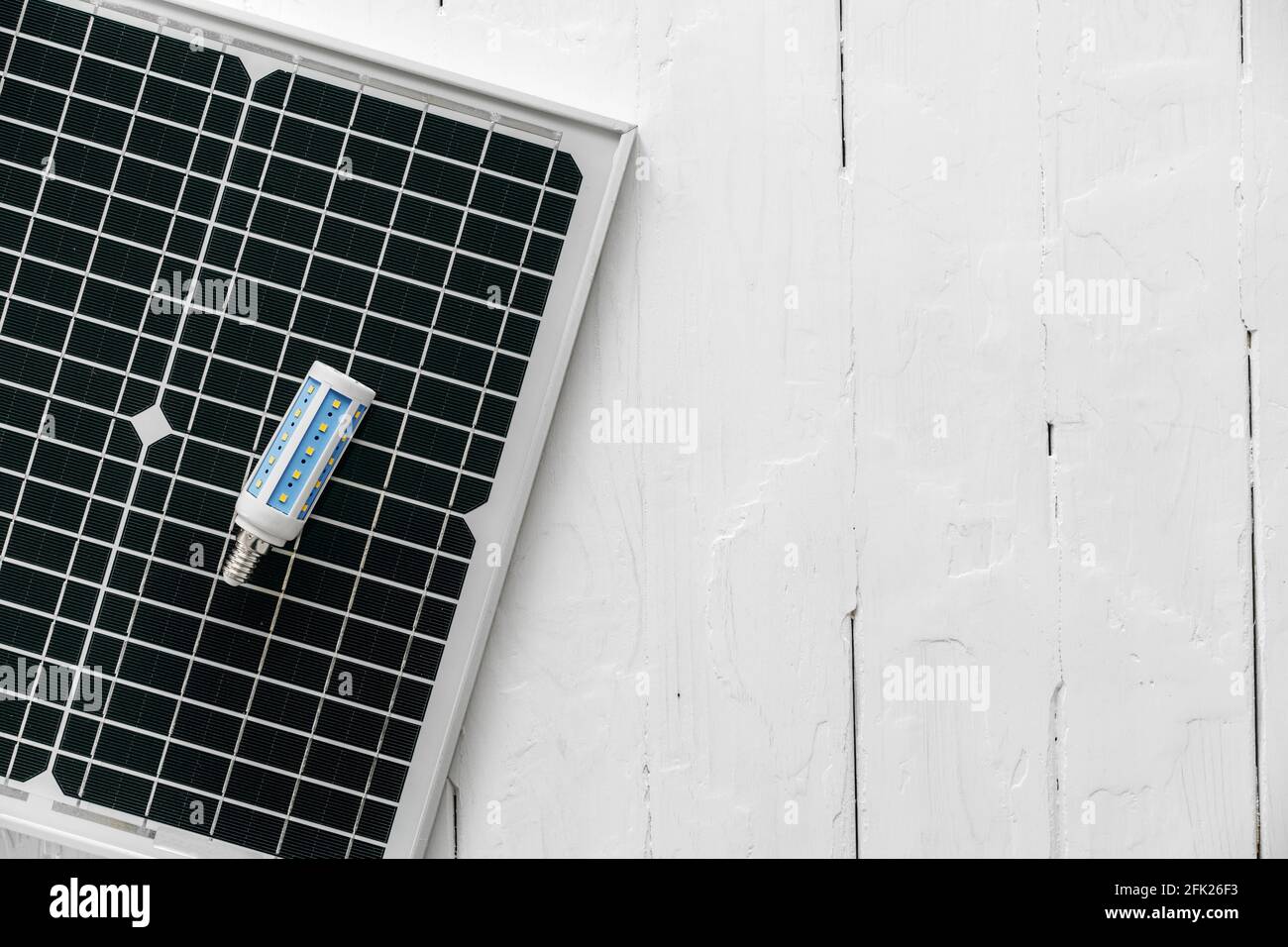 Solar energy panel and light bulb, green energy Stock Photo - Alamy