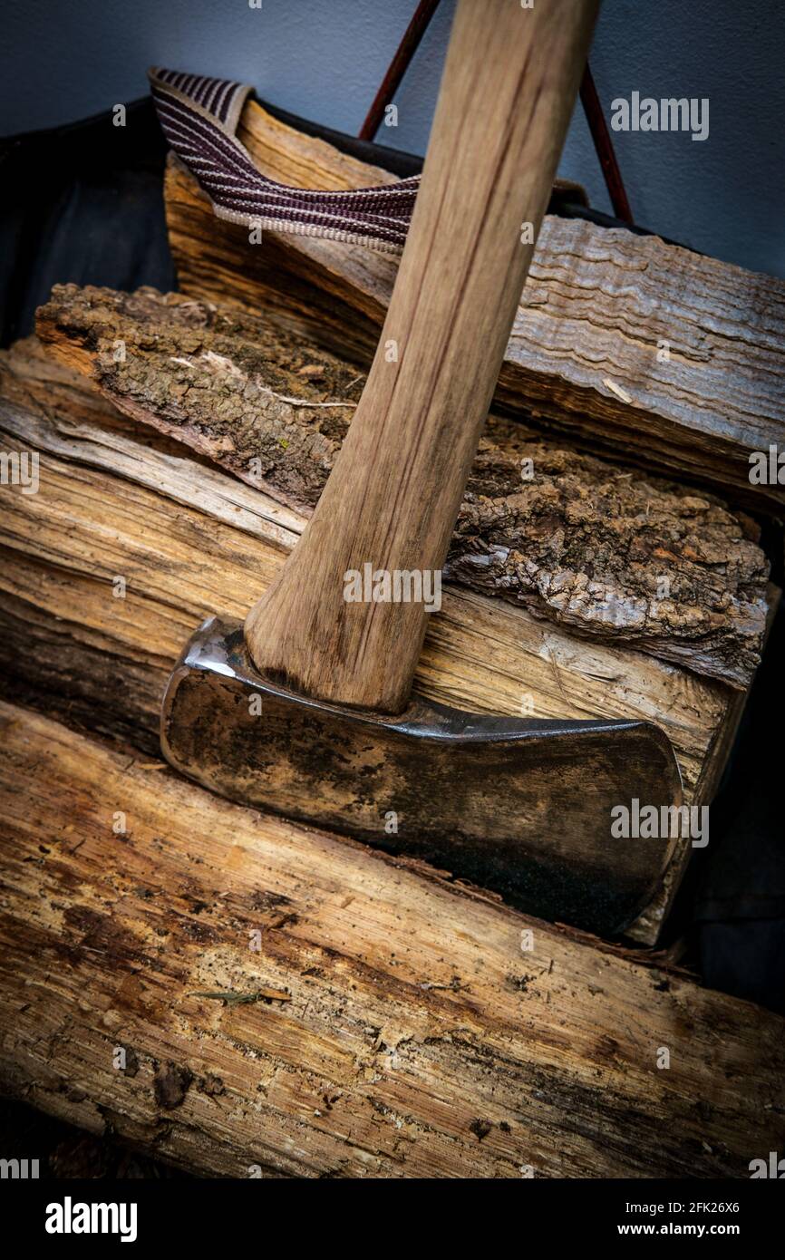 Dark moody rustic worn axe with chopped wood for fire during cold ...