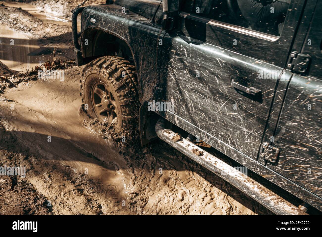 Offroad car driving through the forest road of mud Stock Photo - Alamy
