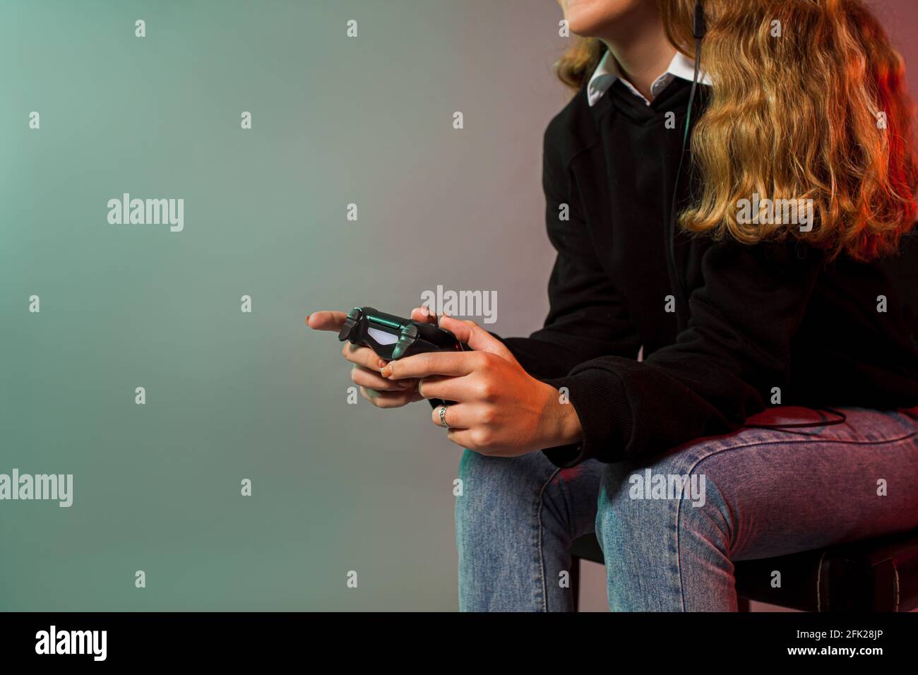 Girl holding joystick and play virtual game Stock Photo - Alamy