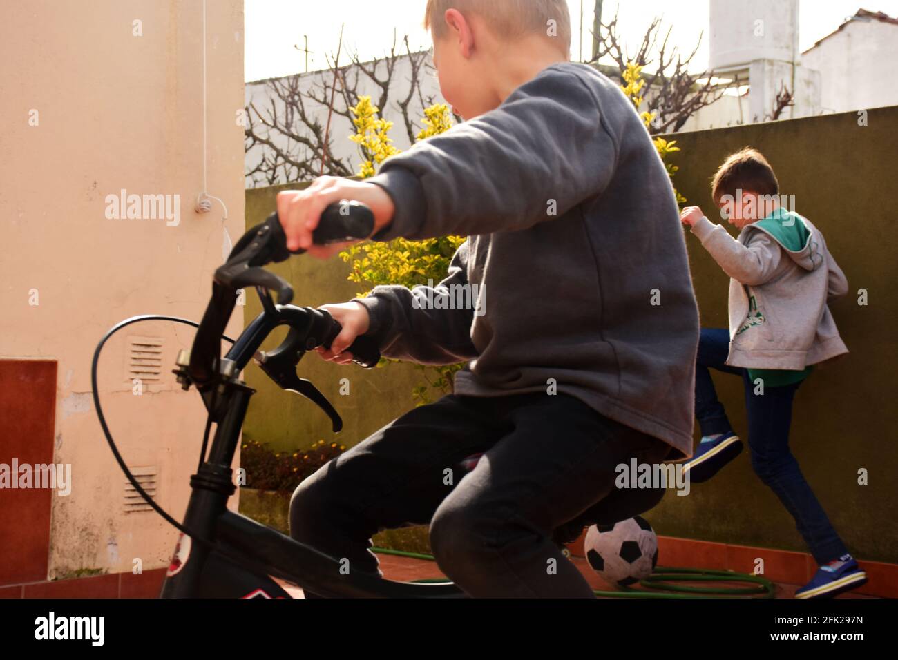 Boys playing with their bicycle hi-res stock photography and images - Alamy