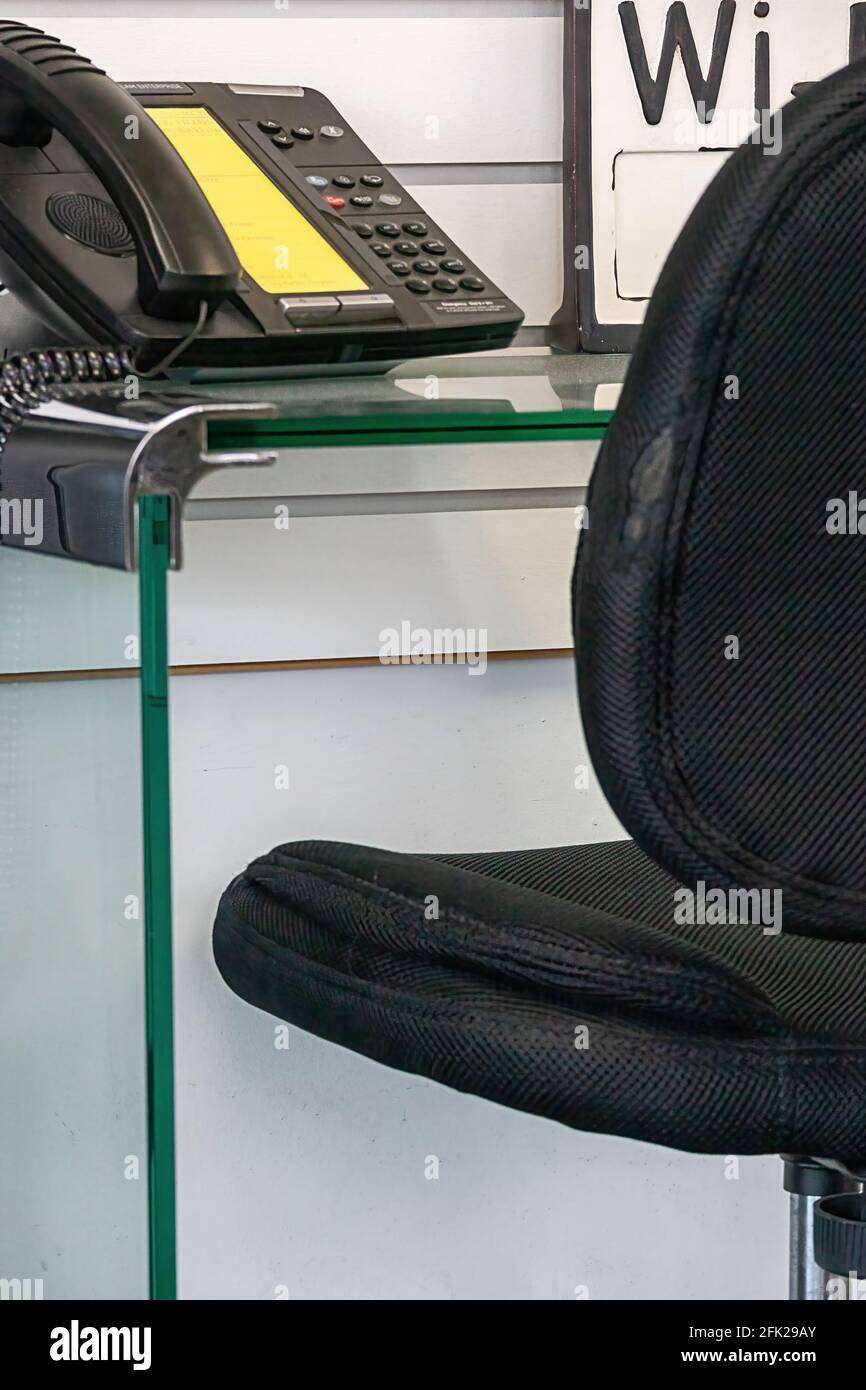a corded phone set on a glass office desk Stock Photo - Alamy