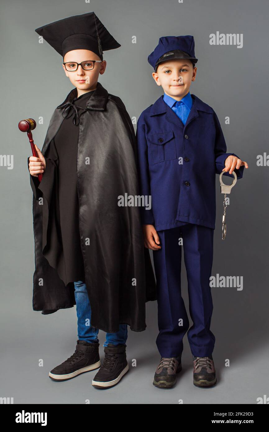 The little boys dressed in a costumes of officer and judge Stock Photo ...