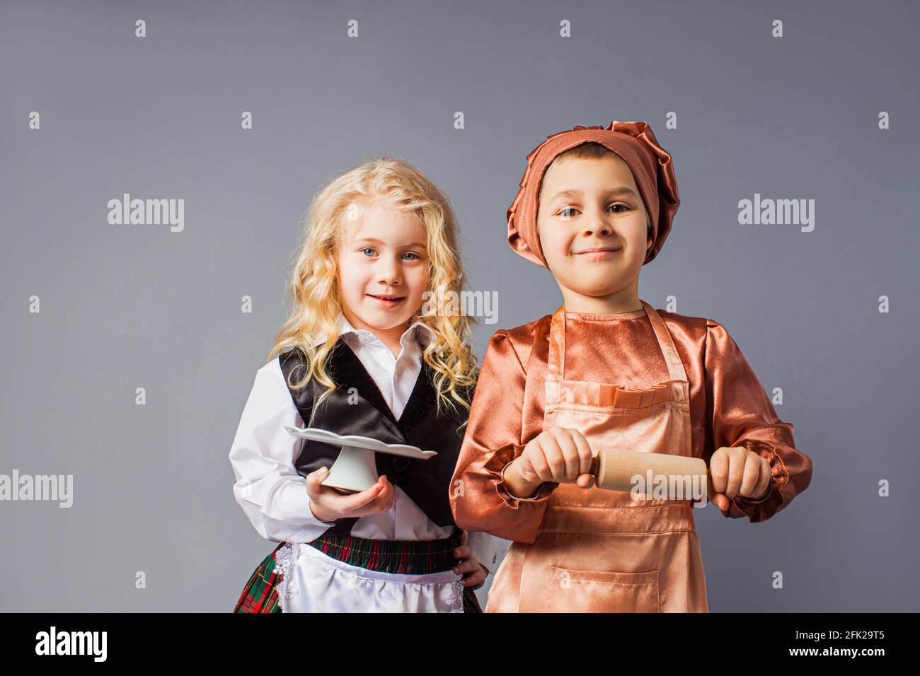 Kids pose in the costumes of a waiter and a cook Stock Photo - Alamy