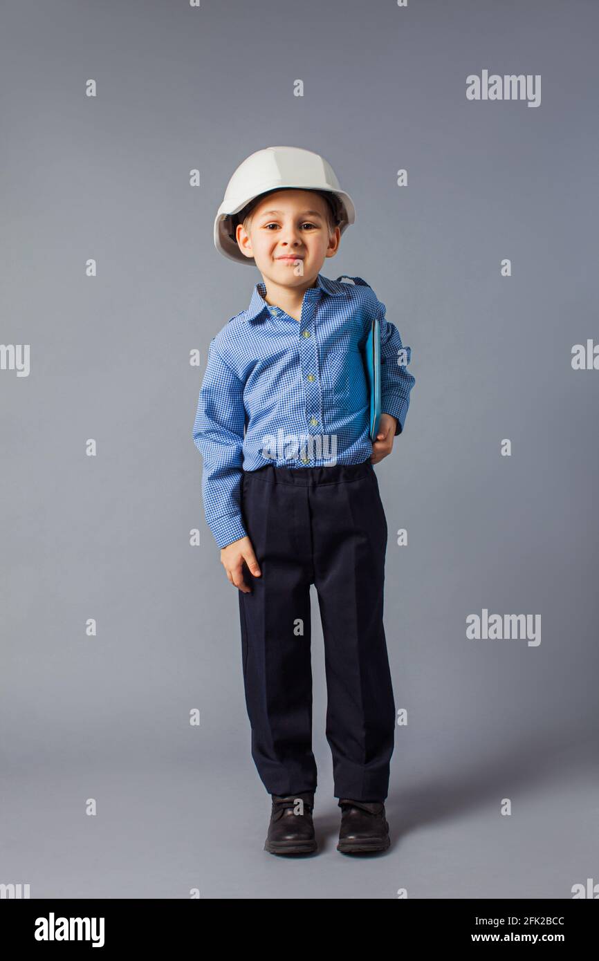 The little boy with tablet dressed in a costume of engineer Stock Photo ...
