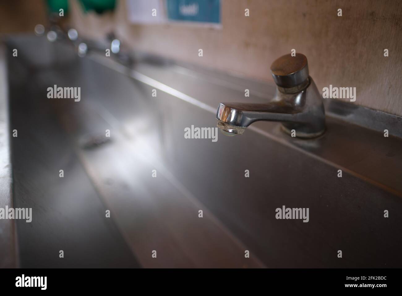 Perspective view of a public restroom hand washing sink. Close-up of a ...