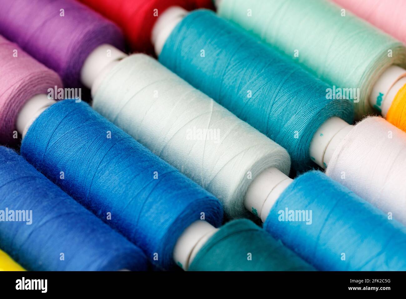 Close up of colored thread coils, thread spools background Stock Photo ...