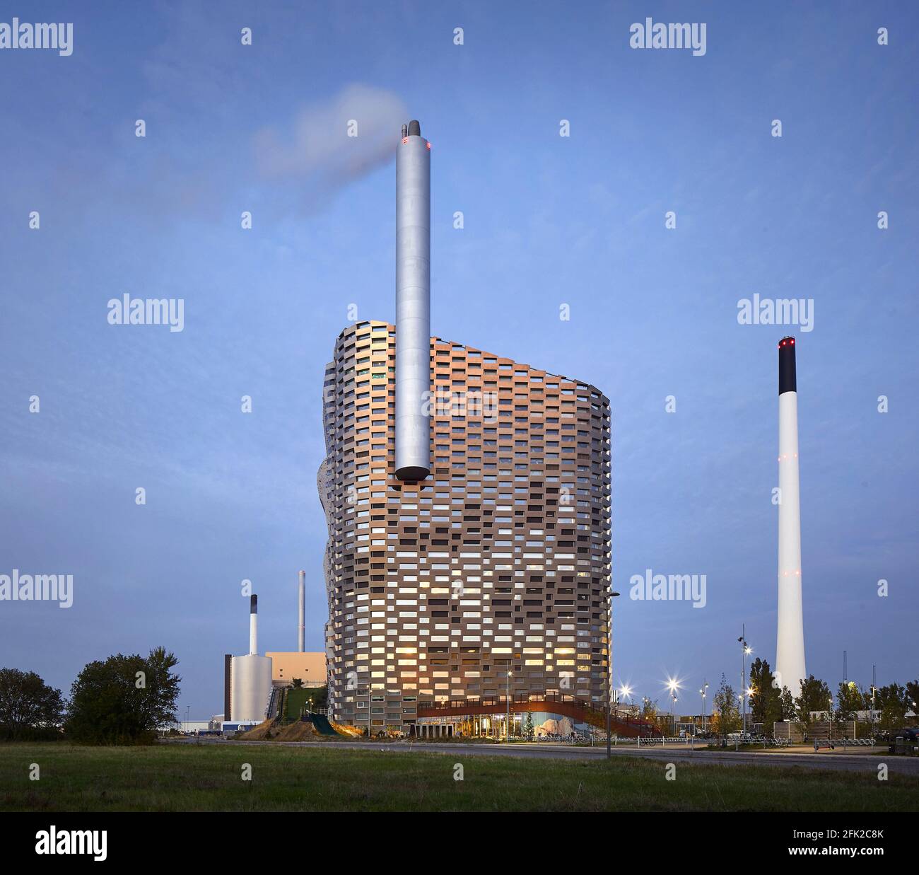 Power plant at dusk with lit interiors. CoppenHill Power Plant ...