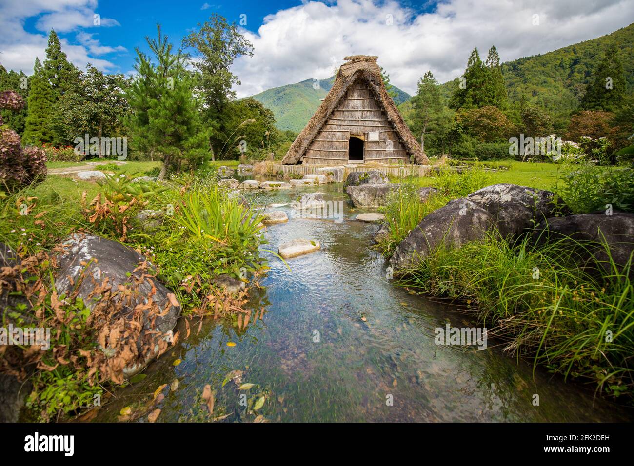 Small traditional Japanese house by river stream. Building with a ...