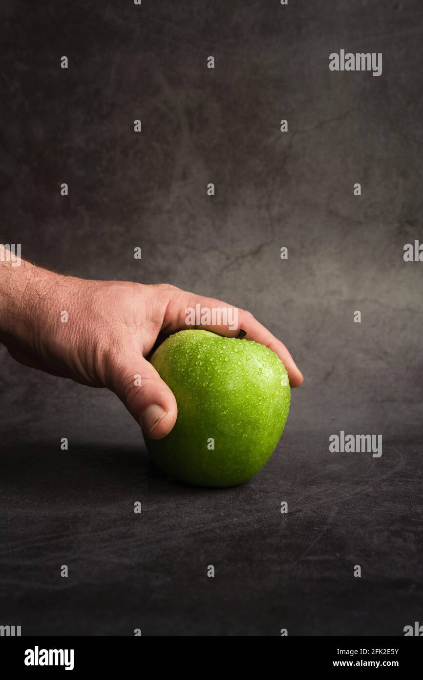 one green apple male hand Stock Photo - Alamy