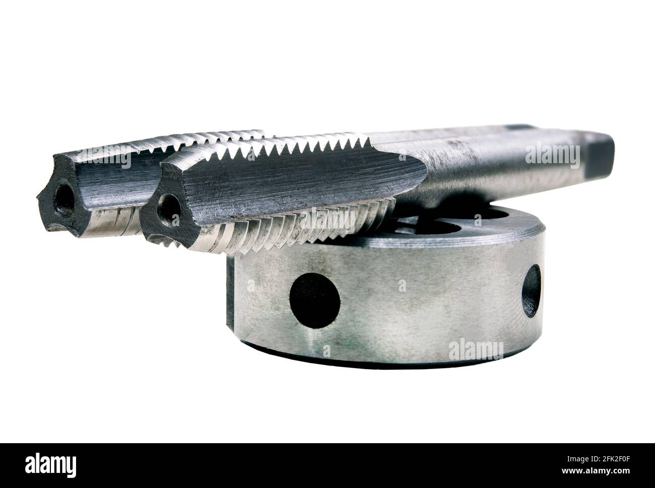 A metal tap for cutting metric threads. Accessories used in a ...