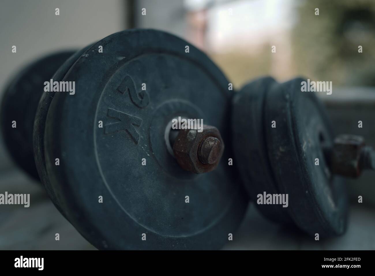 Closeup of old rusty two kilogram dumbells and weights in a gym Stock ...