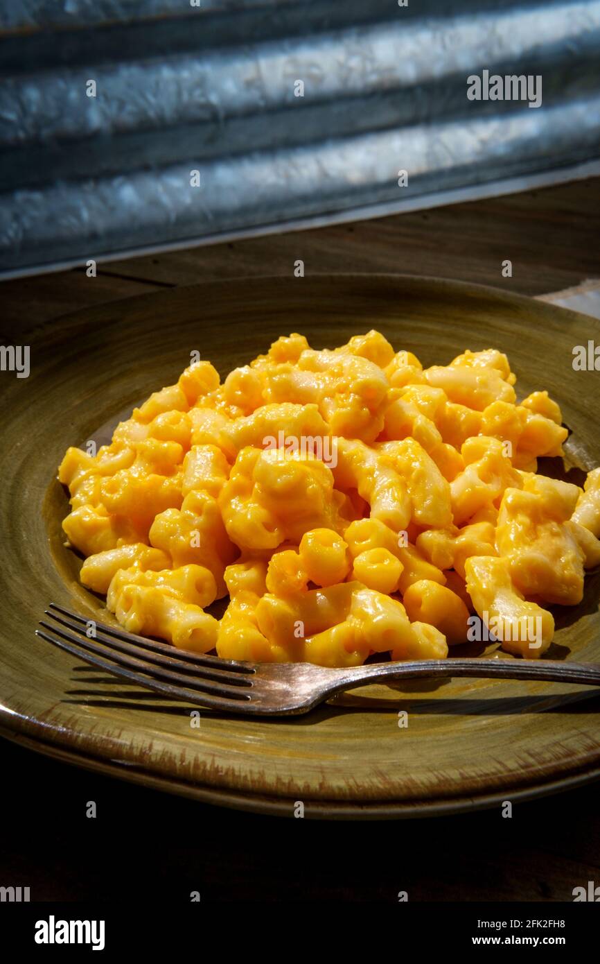 Delicious macaroni and cheese on wooden table with dramatic dark and moody lighting Stock Photo ...