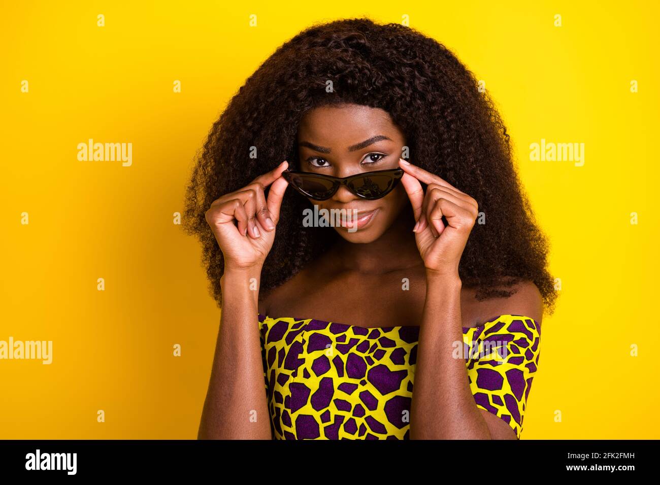 Portrait of attractive modern chic girl touching specs posing isolated ...