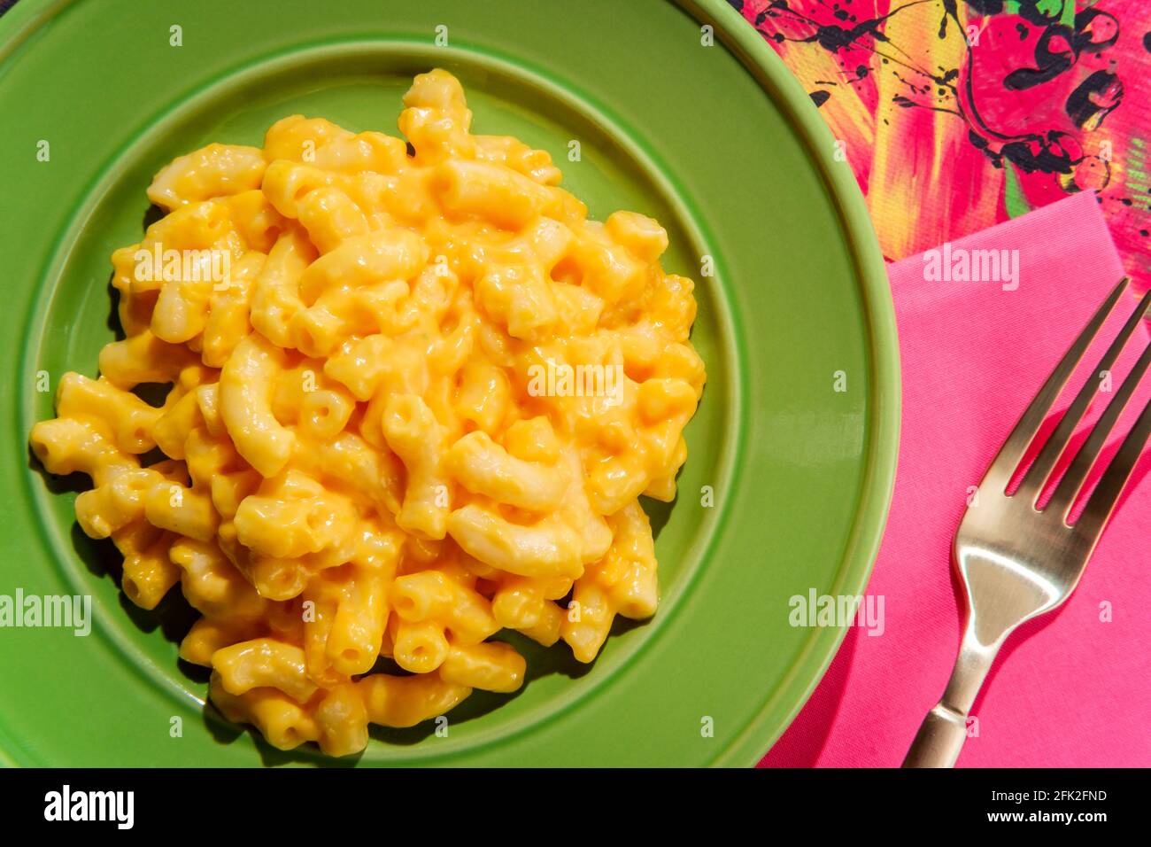 Stylized pop fashion macaroni and cheese on abstract pink background ...