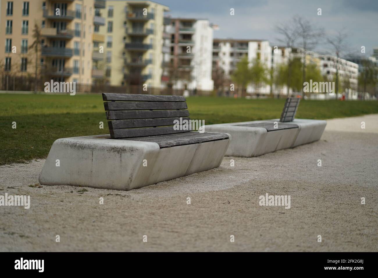 Selective focus of urban abstract wooden benches installed in stone ...