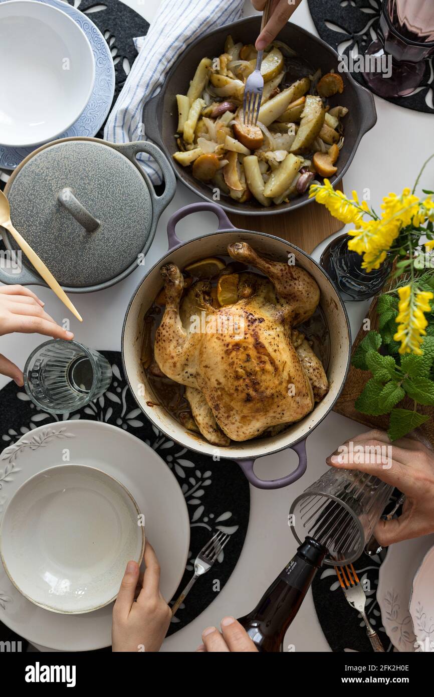 Familiar reunion around a delicious roast chicken with lemon over an ...