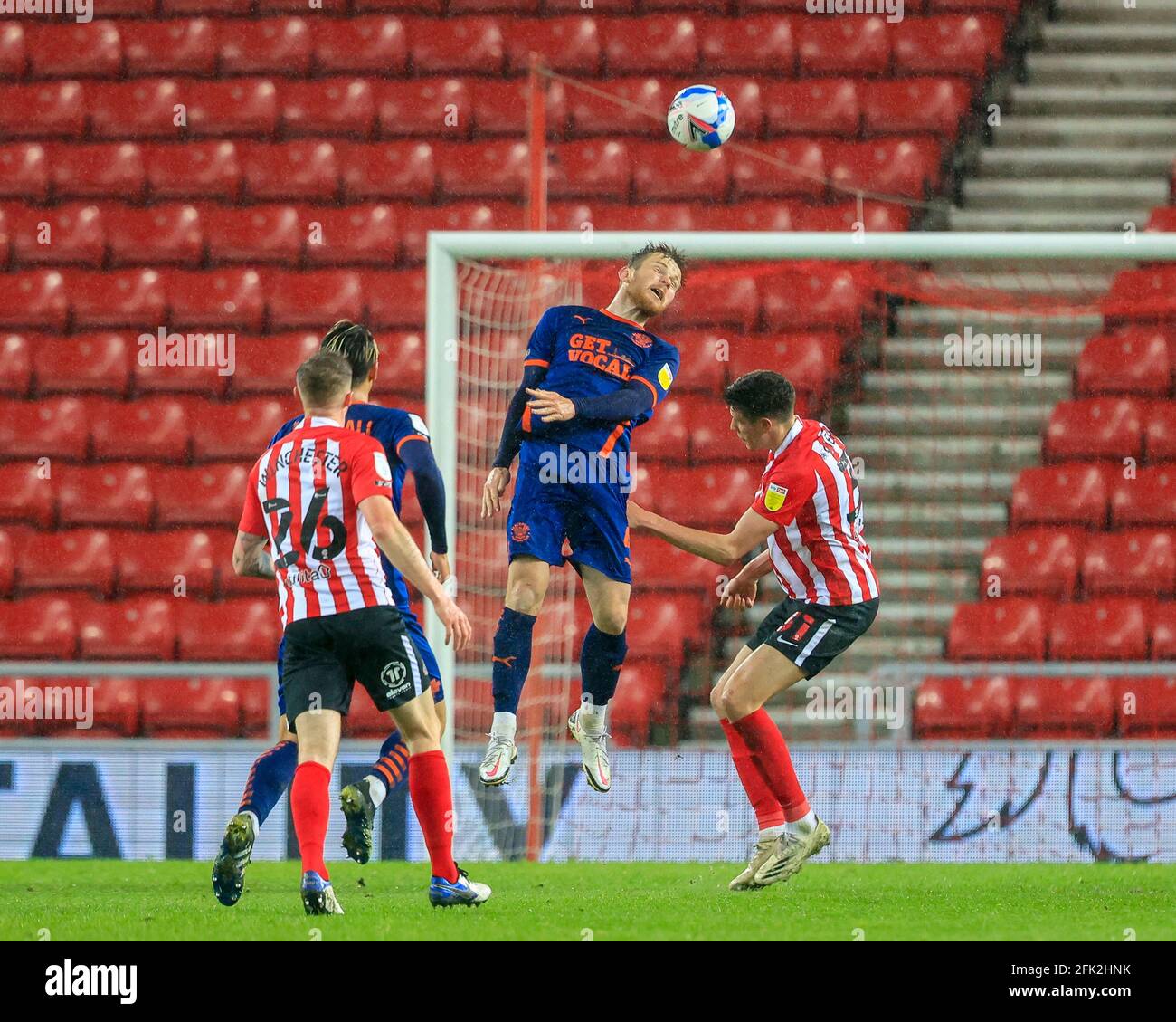 Jordan Thorniley #4 of Blackpool in an aerial challenge with Lynden ...
