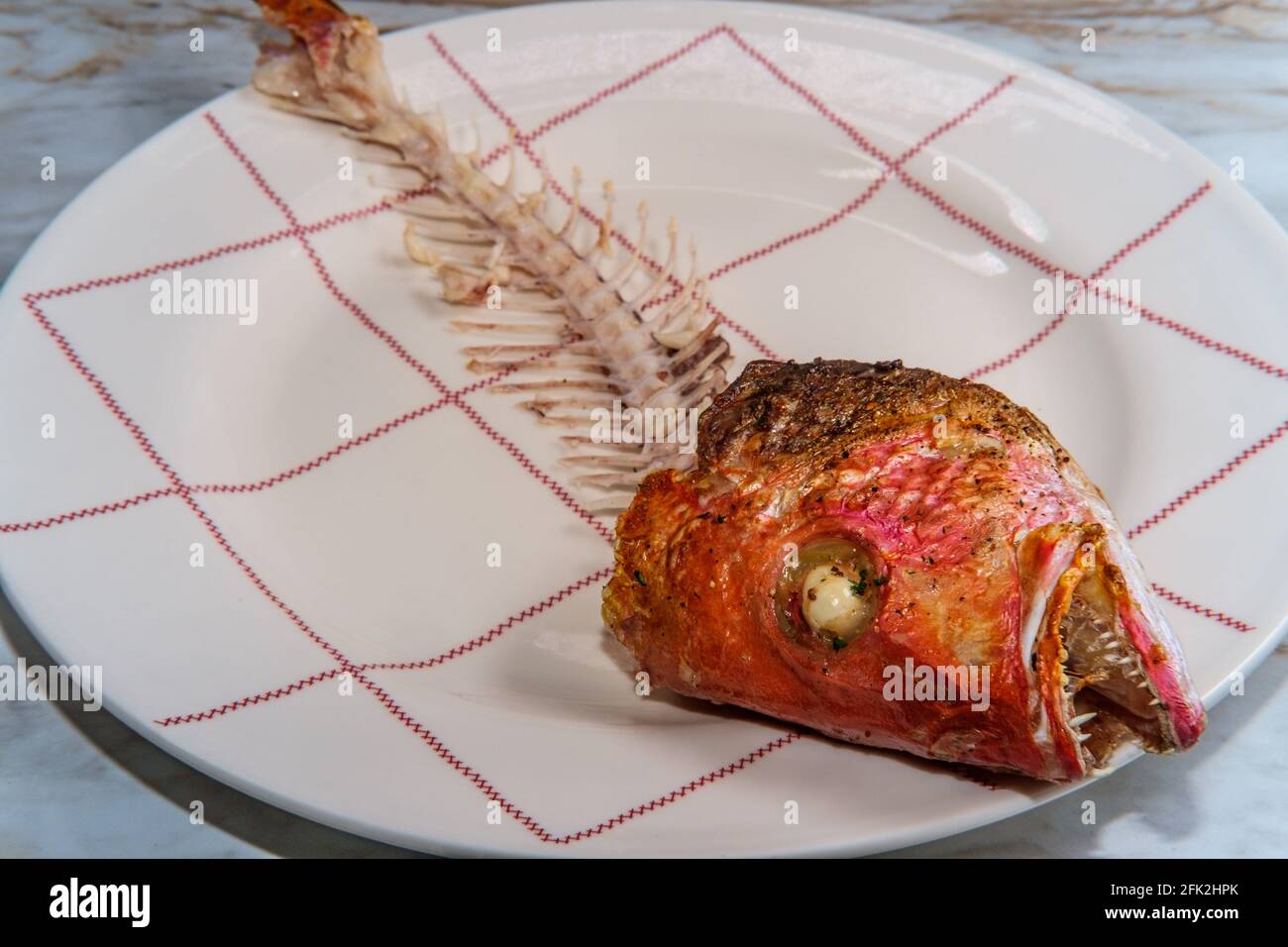 Red snapper fish spine bone with head after finishing dinner Stock ...
