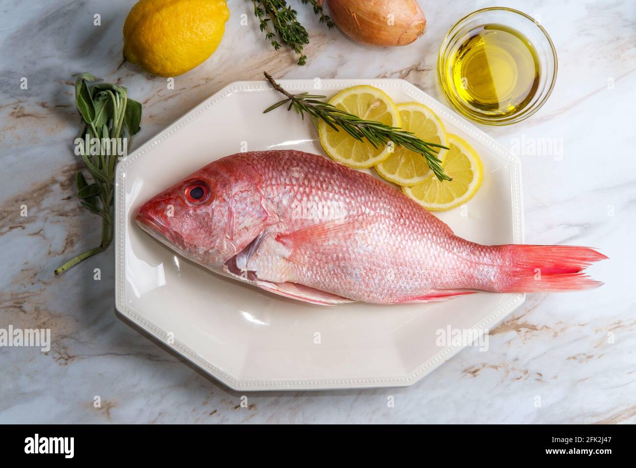 Fresh whole raw head-on red snapper with seasoning ingredients Stock ...