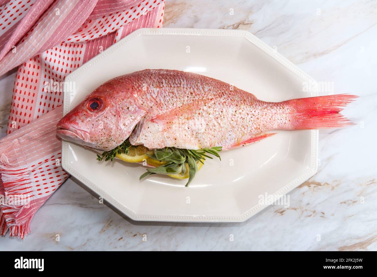 Fresh whole raw head-on red snapper stuffed seasoned and ready to be ...