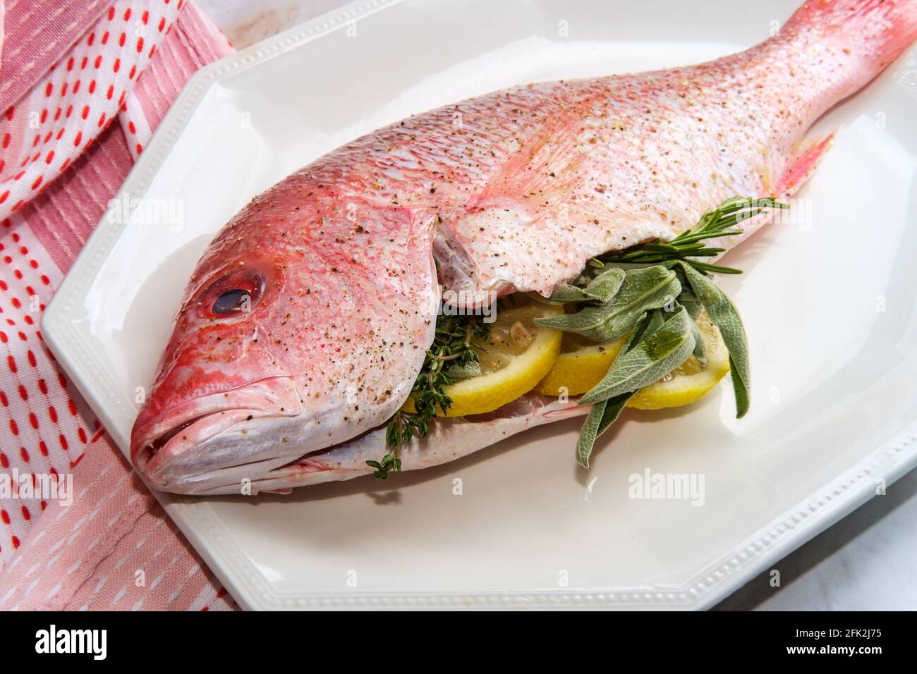 Fresh whole raw head-on red snapper stuffed seasoned and ready to be ...