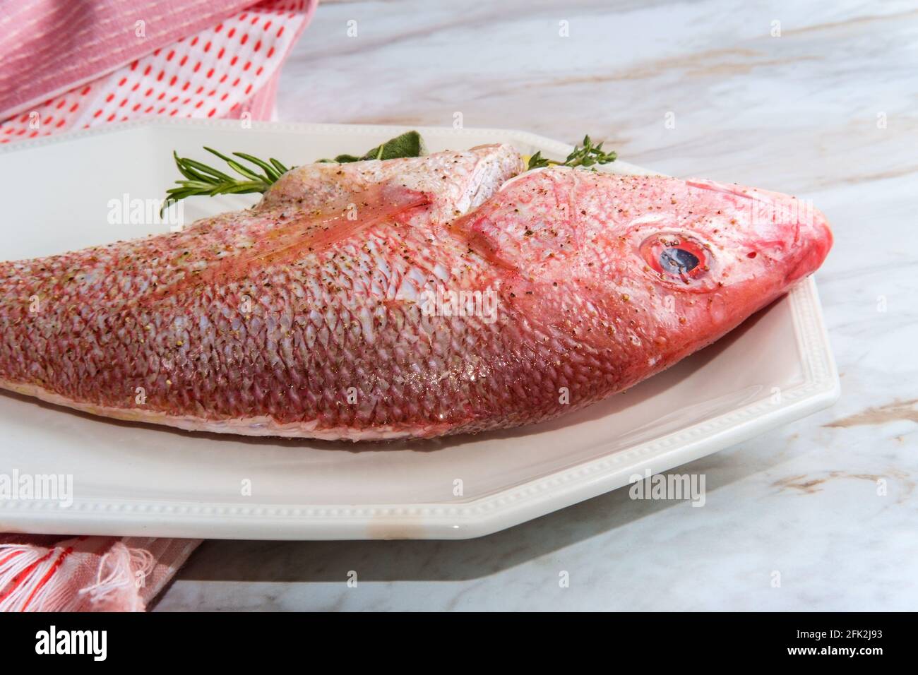 Fresh whole raw head-on red snapper stuffed seasoned and ready to be ...
