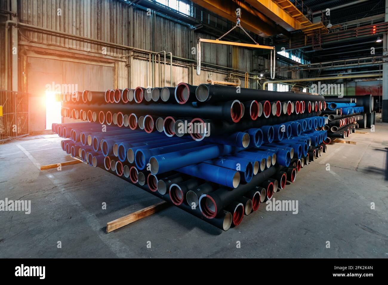 New cast iron pipes for pipeline construction in warehouse Stock Photo ...