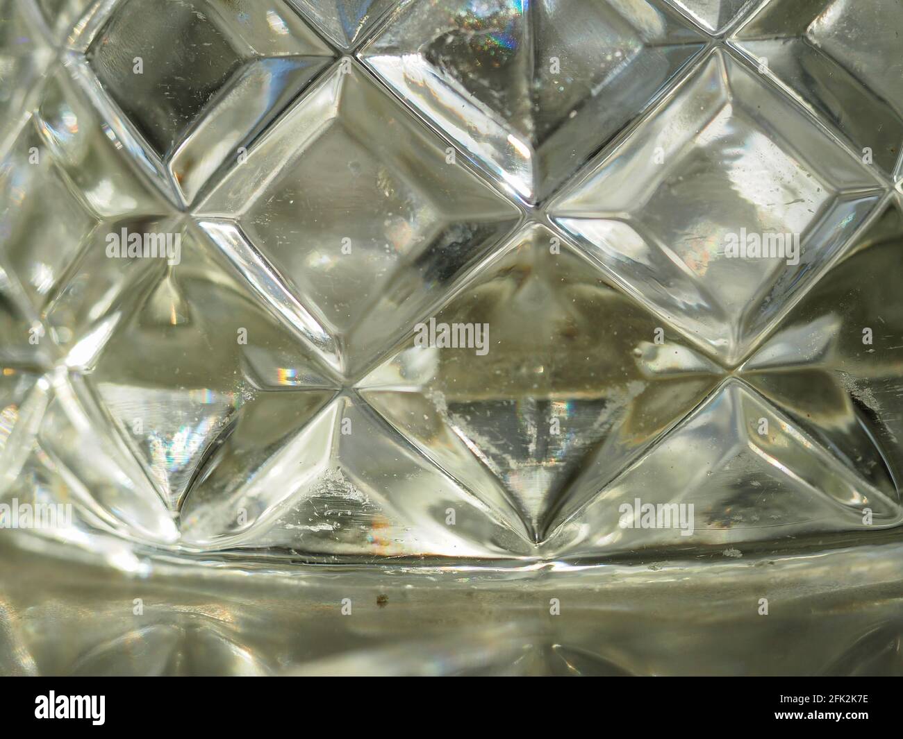 The bottom of a crystal vase with the sunlight shining through it ...