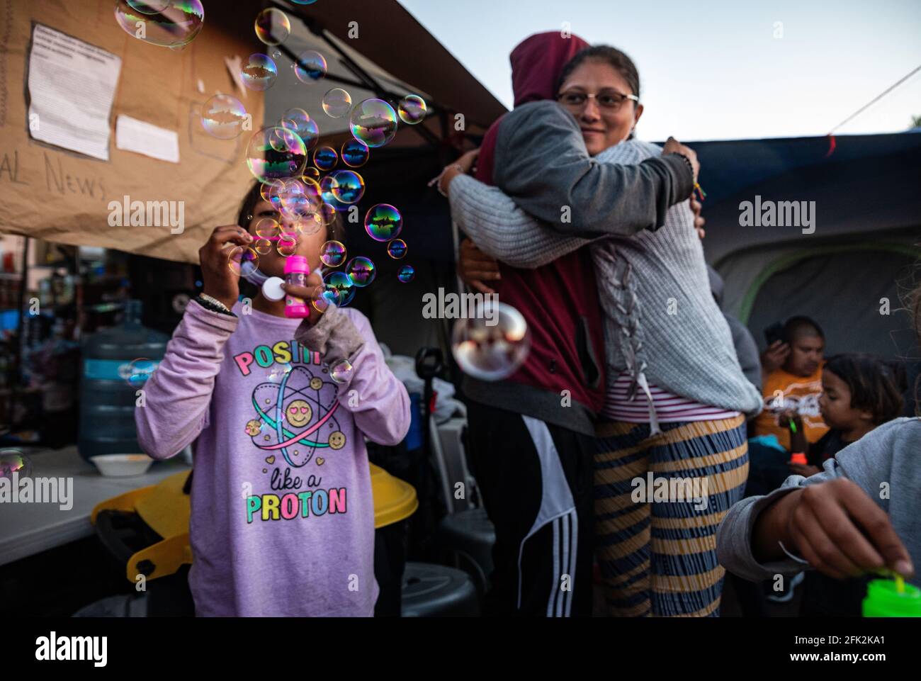 Tijuana, Mexico. 6th Apr, 2021. Children play with bubbles besides a ...