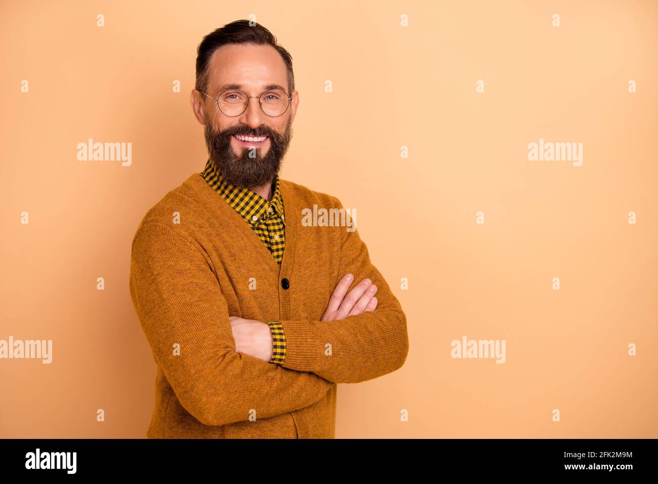 Photo of self-assured handsome man look camera crossed hands wear ...