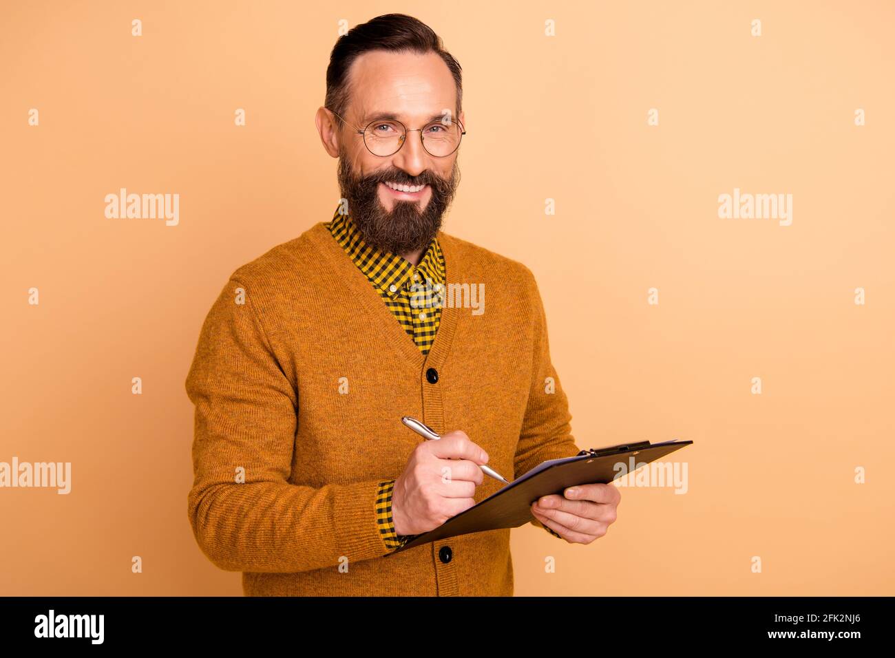 Photo of cheerful agent hold clipboard pen write wear specs brown ...