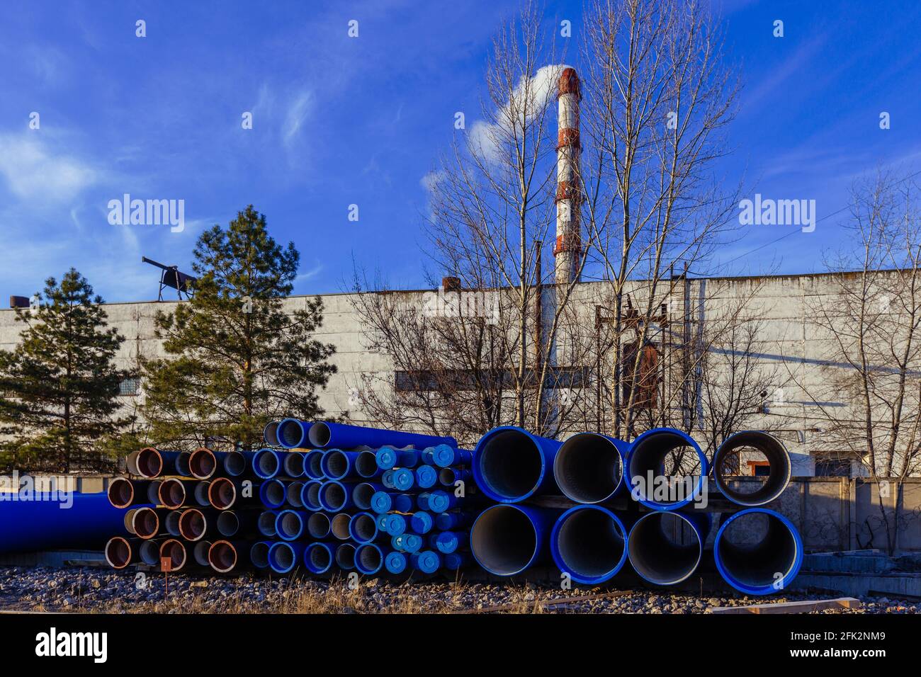 Stack of cast iron pipes in loading area waiting for transportation ...