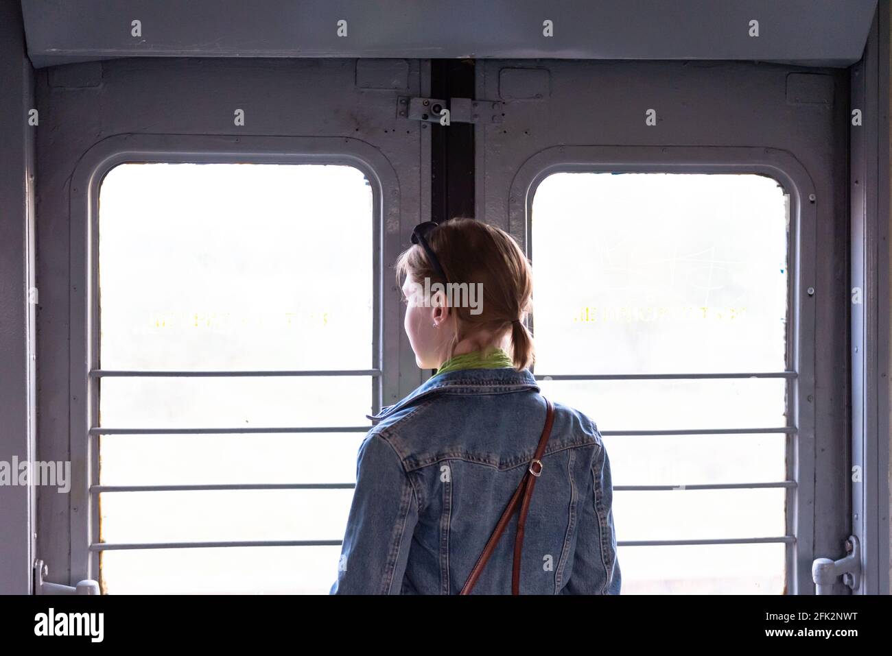 Girl sitting alone in train hi-res stock photography and images - Alamy