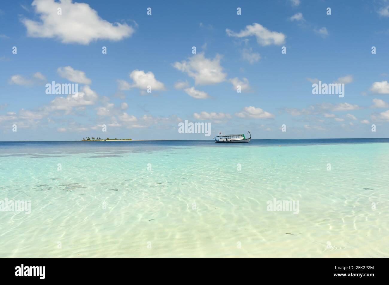 Beautiful tropical background of shallow water on a beach with boats ...