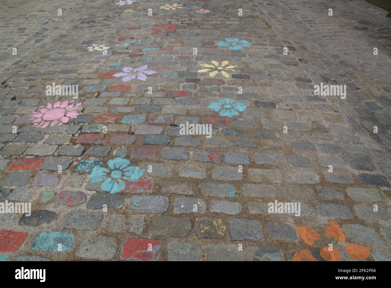Cobblestone pavement with colorful flowers painted on it in the ...