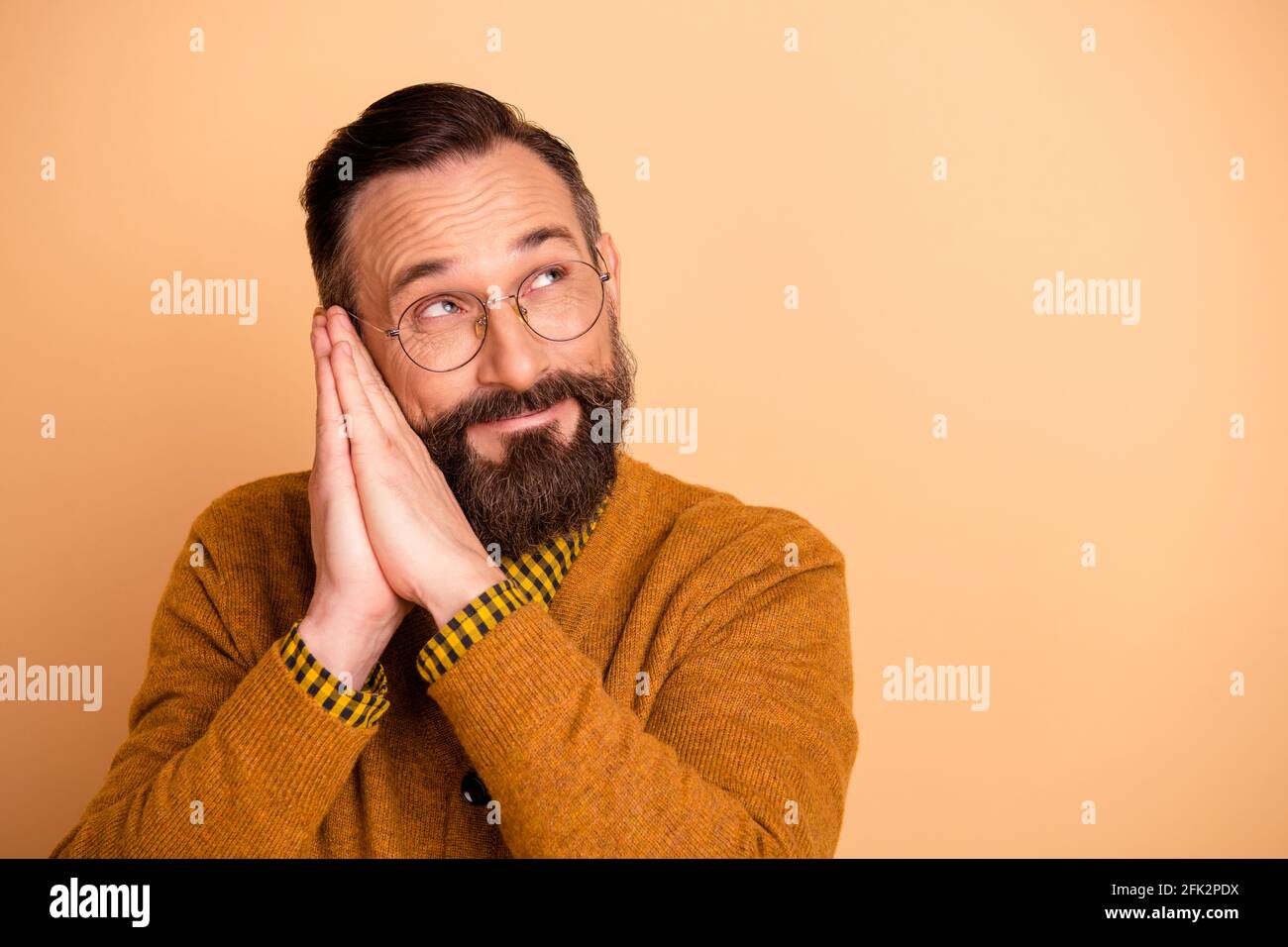 Photo of dreamy man sleep with hands under face look empty space wear ...