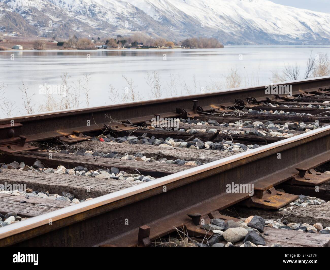 Railroad tracks running along the snow covered Columbia river valley ...