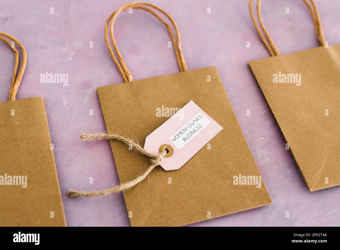 women-owned business tag on shopping bag surrounded by competitors ...